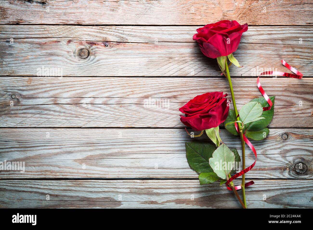 Bouquet of red roses on wooden rustic background Stock Photo - Alamy