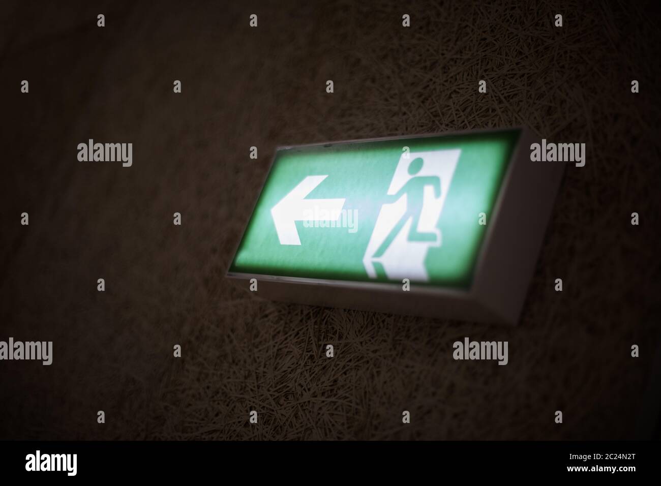 Color image of a green exit sign above a door Stock Photo - Alamy