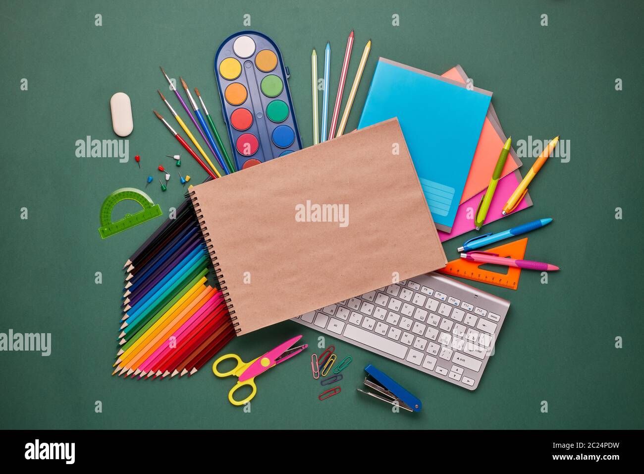 Blank writing-book, computer keyboard, stationery accessories: pencils ...
