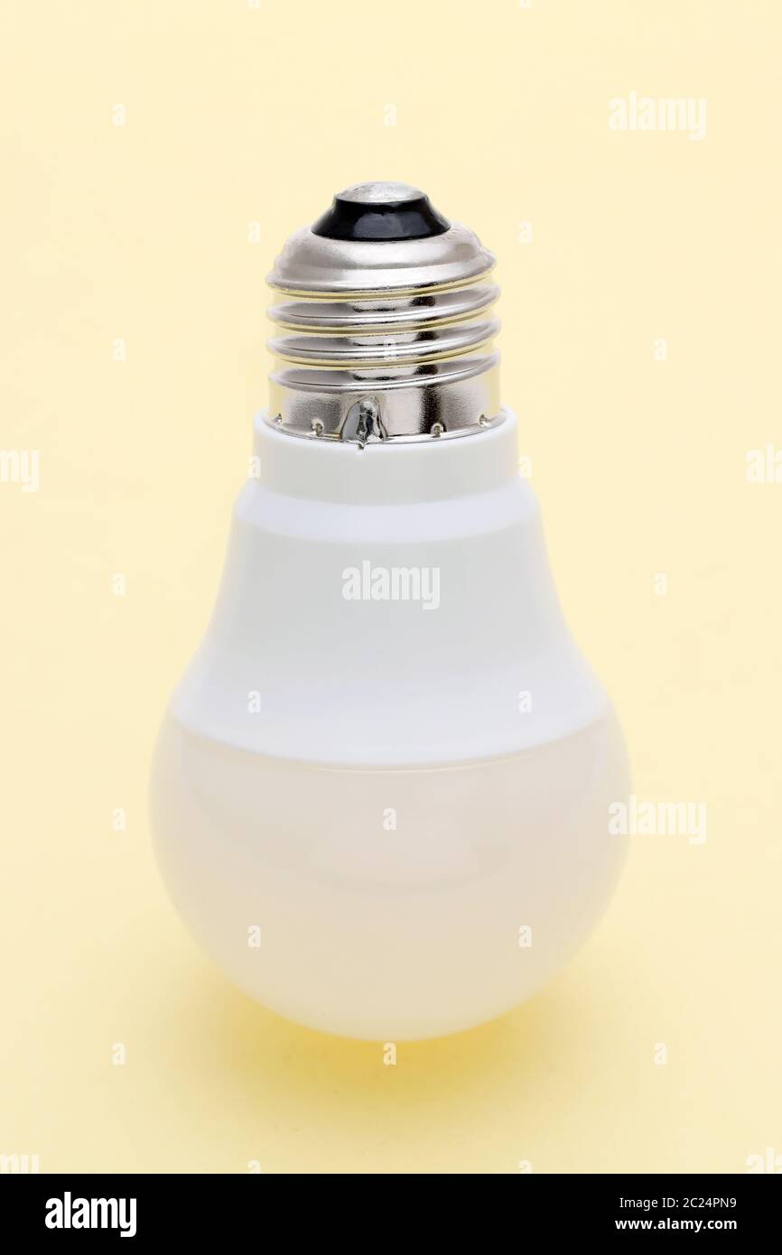 LED energy saving bulb on yellow background Stock Photo - Alamy