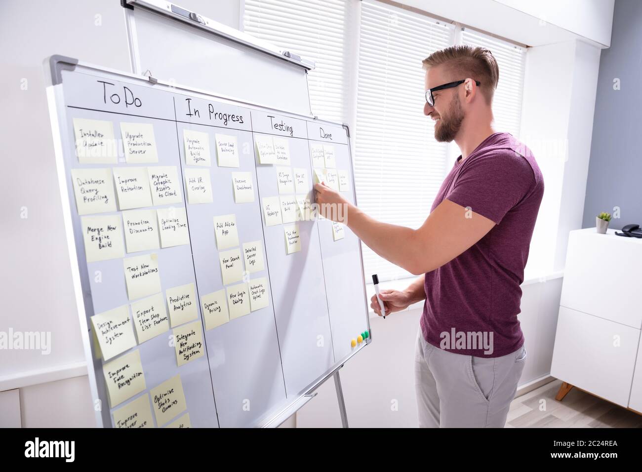 Person sticking note on white hi-res stock photography and images - Alamy