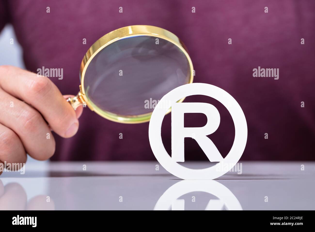 Human Hand's Holding Magnifier Looking Registered Trademark Icon Over ...