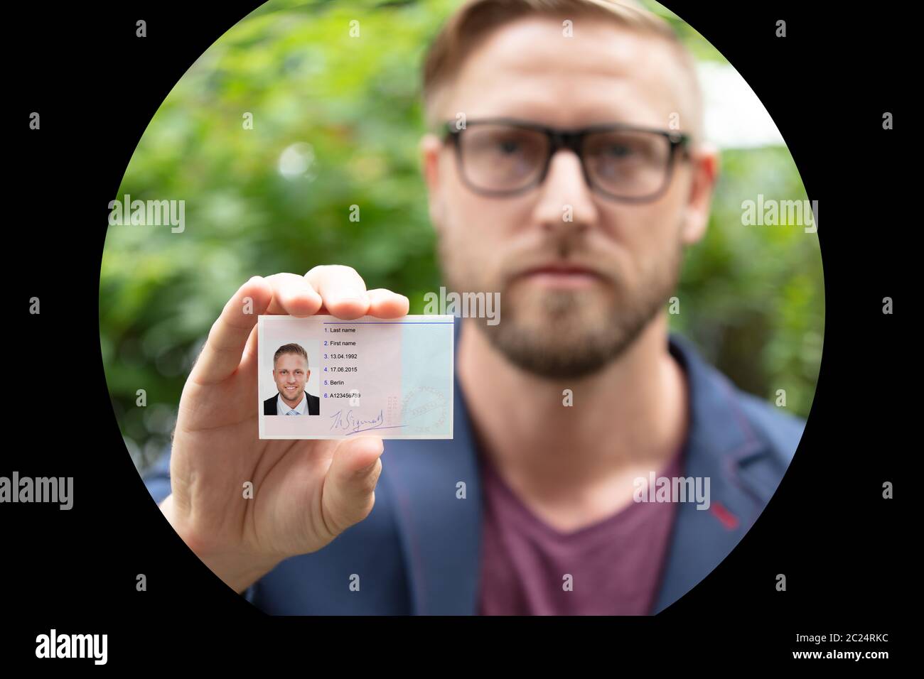 Bailiff standing at house entrance showing id Stock Photo - Alamy