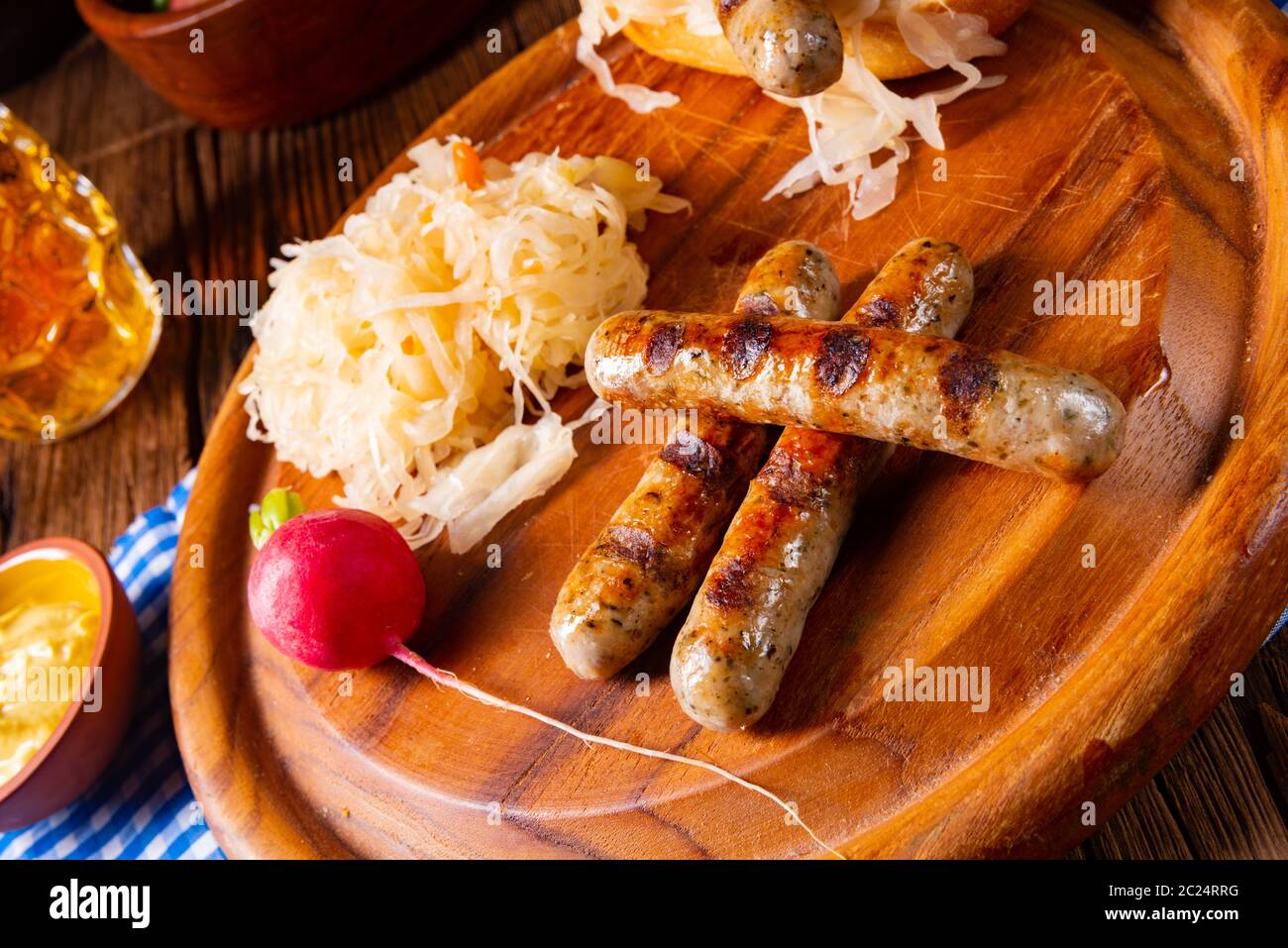 rustic Thuringian bratwurst with sauerkraut and roll Stock Photo - Alamy