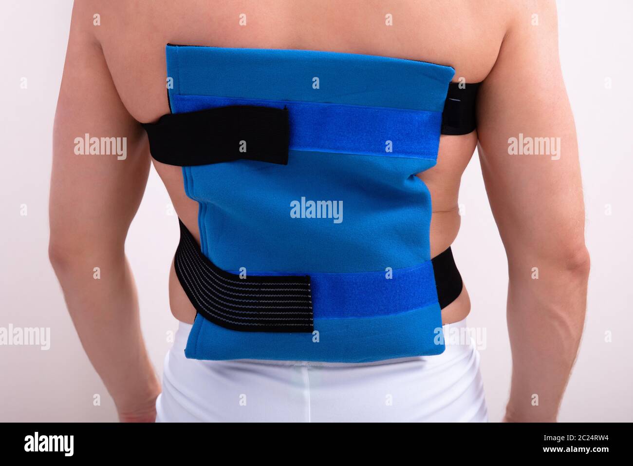 Mid Section Of A Shirtless Man Wearing Back Ice Pack Standing Against ...
