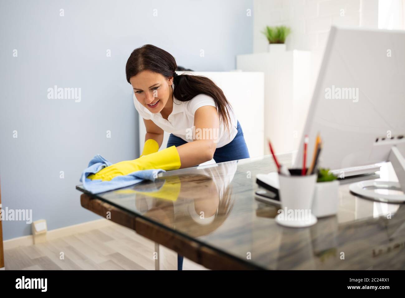 Female janitor cleaning table hi-res stock photography and images - Alamy