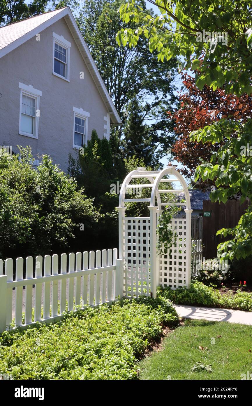 The white fence and gate are very traditional looking Stock Photo - Alamy