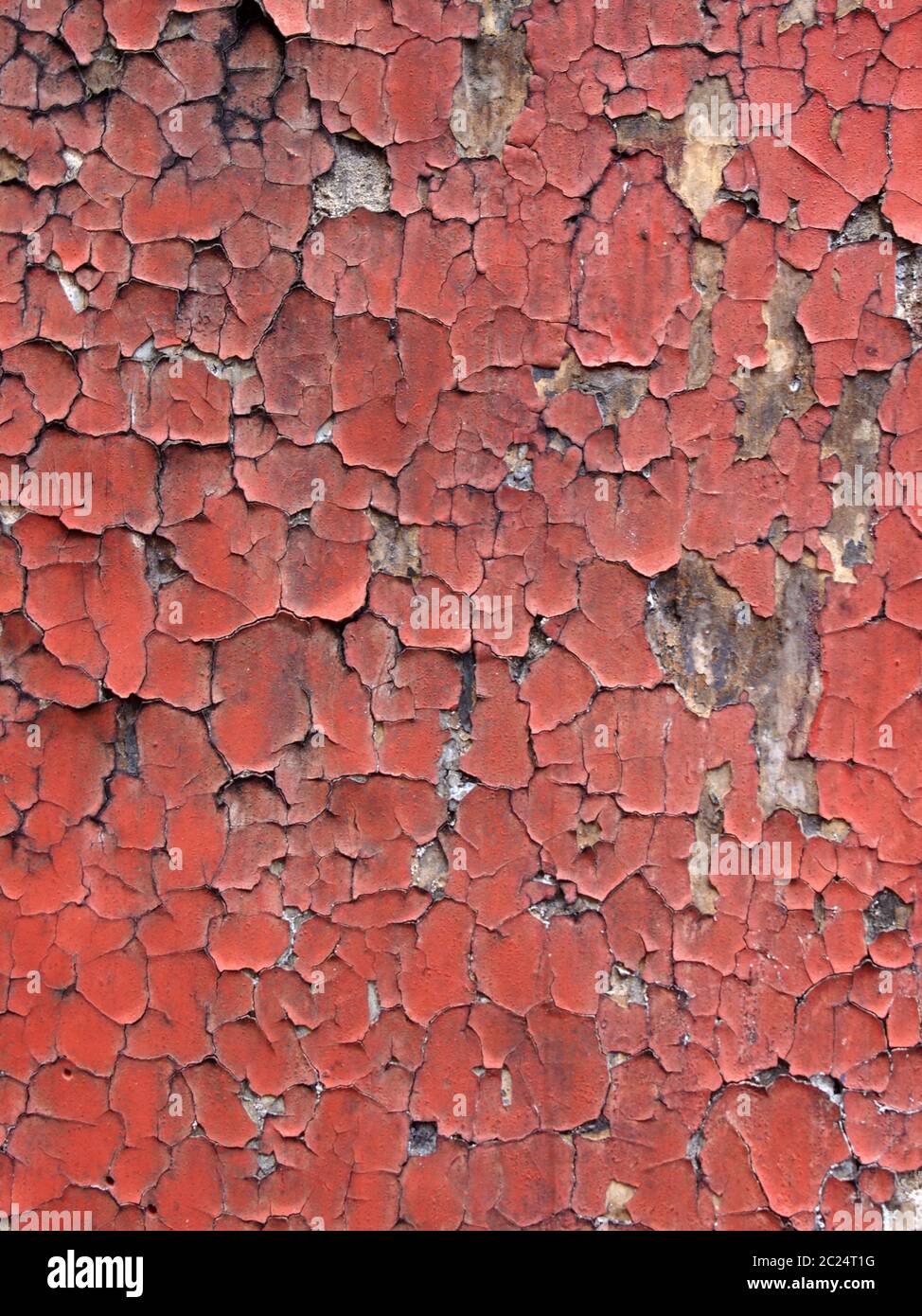 ancient faded cracked peeling red paint forming an abstract pattern on ...
