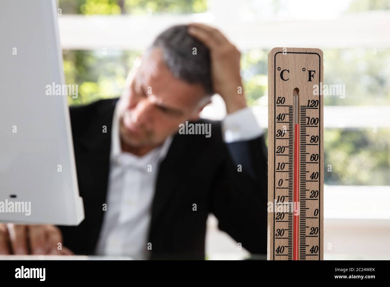 Thermometer In Front Of Businessman Working During Hot Weather In The ...