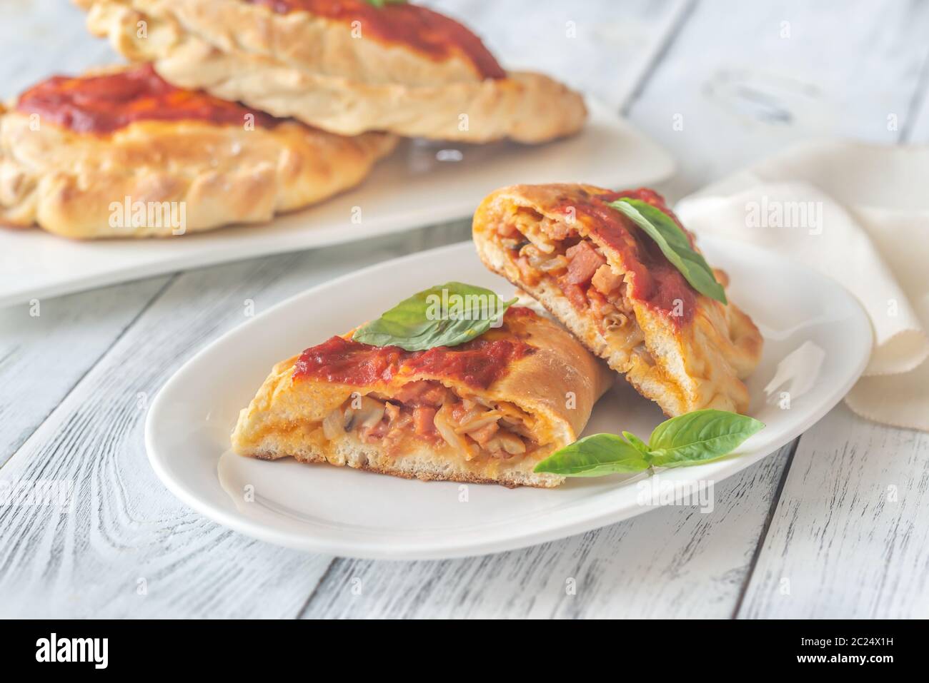 Homemade calzone stuffed with pancetta and mushrooms: cross section ...