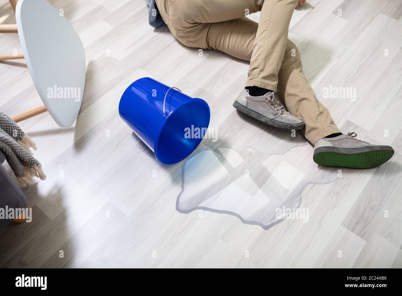 Mature Man Falling On Wet Floor In Front Spilled Bucket Of Water At ...