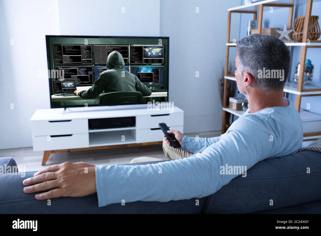 Rear View Of Man Watching Television At Home Stock Photo - Alamy