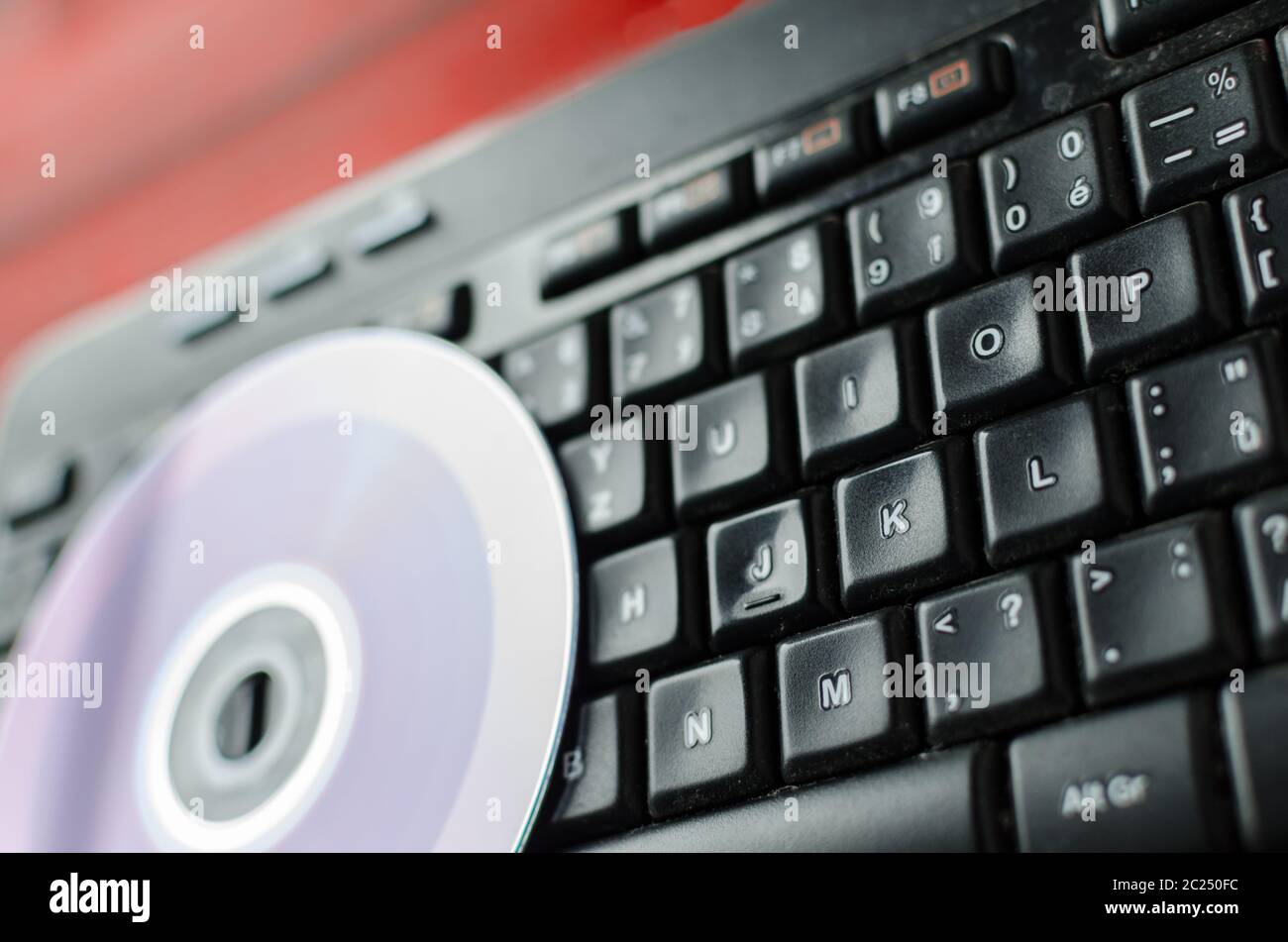 Keyboard with CD, CD half copy and shiny Stock Photo - Alamy