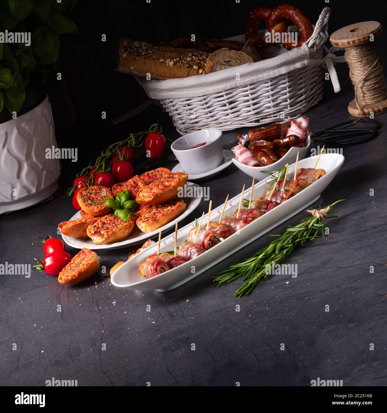 dates wrapped in bacon and delicious tapas Stock Photo - Alamy