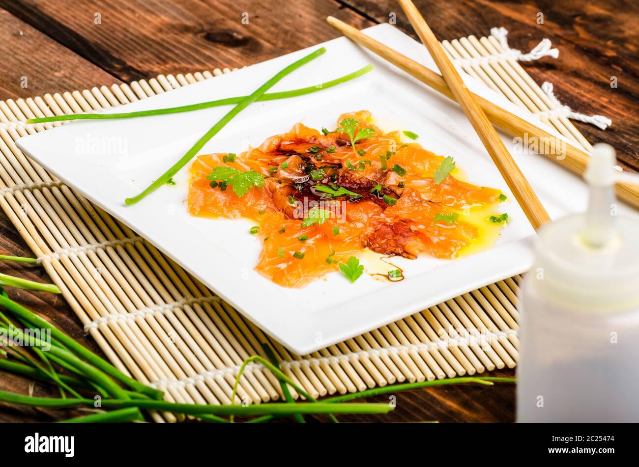 Sashimi new style - hot oil, herbs and soy souce Stock Photo - Alamy