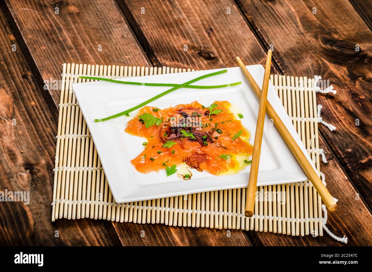 Sashimi new style - hot oil, herbs and soy souce Stock Photo - Alamy
