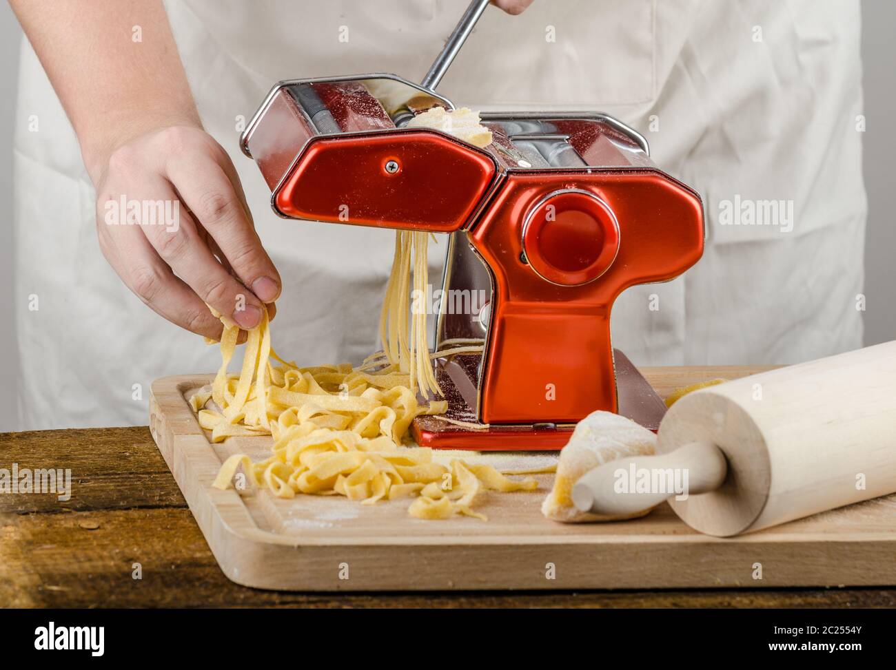 Chef production pasta - Italian pasta grinder, wood board, rolling-pin ...