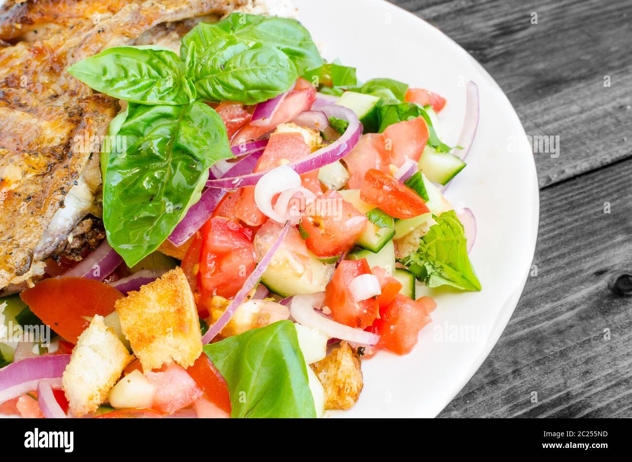 Chicken under a brick with panzanella salad. Pollo al mattone Stock ...