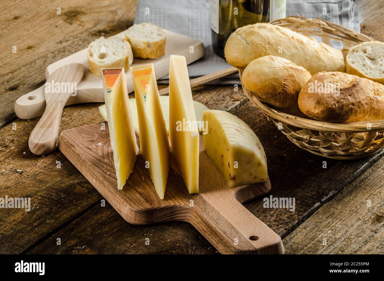 Delicious ripe cheese with crispy baguette and wine, wood board Stock ...