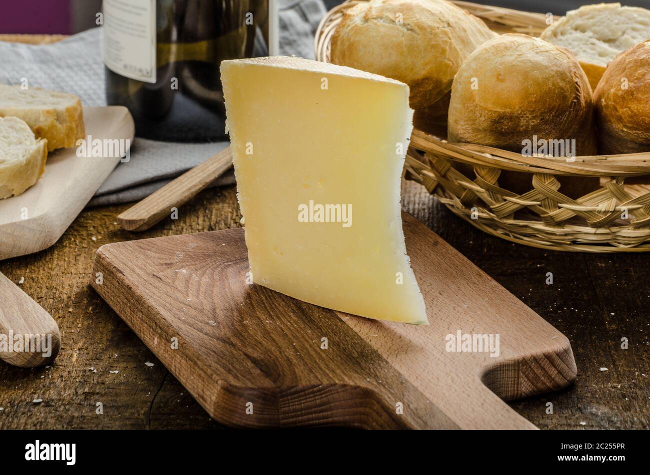 Delicious ripe cheese with crispy baguette and wine, wood board Stock ...