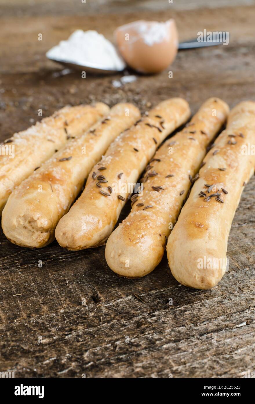 Homemade baked breadsticks on wood table with eggs Stock Photo - Alamy