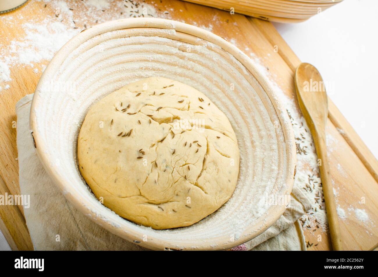 Making bread home in a basket - scuttle on white tablecloth Stock Photo ...