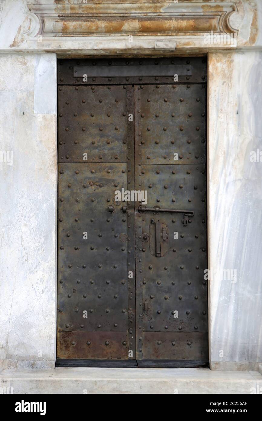Old closed aged rusty metal door entrance Stock Photo - Alamy