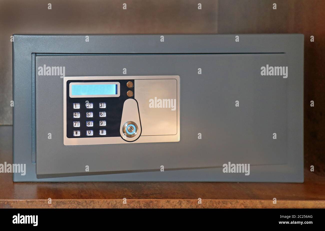 Closed door of electric safe with digital passcode keypad inside hotel ...