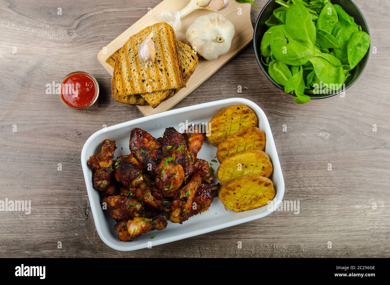 Sticky chicken wings with garlic bread panini, rustic spicy potatoes ...