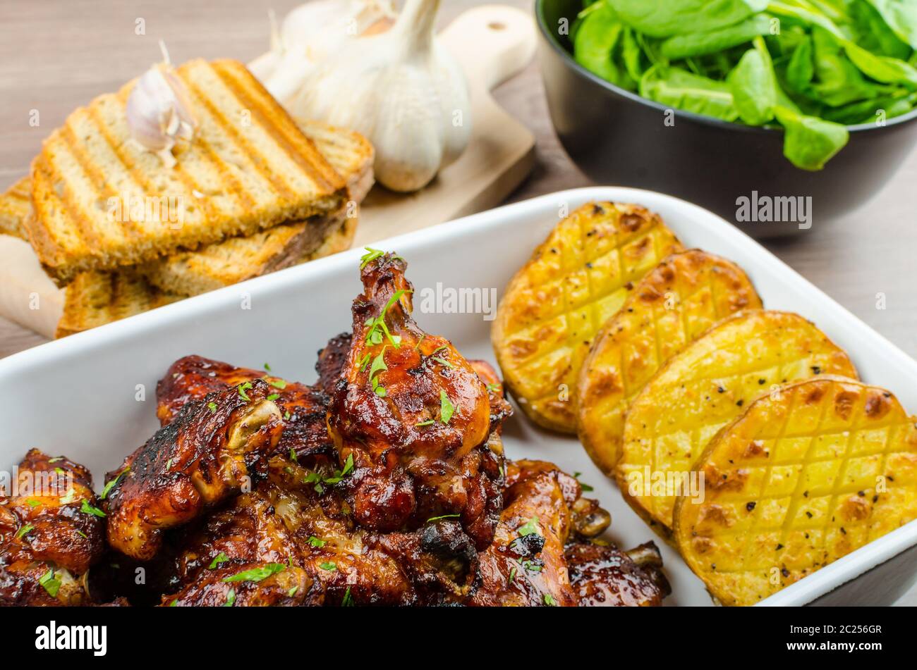 Sticky chicken wings with garlic bread panini, rustic spicy potatoes ...