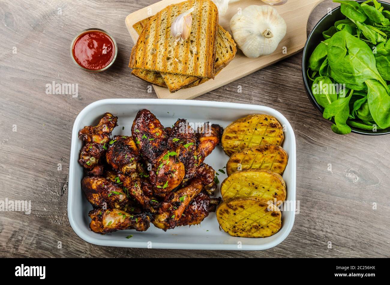 Sticky chicken wings with garlic bread panini, rustic spicy potatoes ...