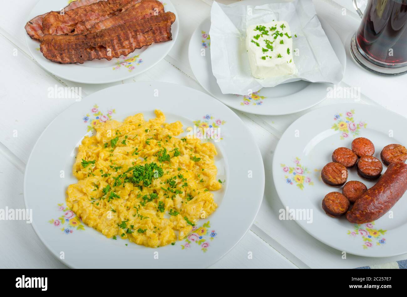 A hearty breakfast of eggs, bacon, sausage and toasted baguette and ...