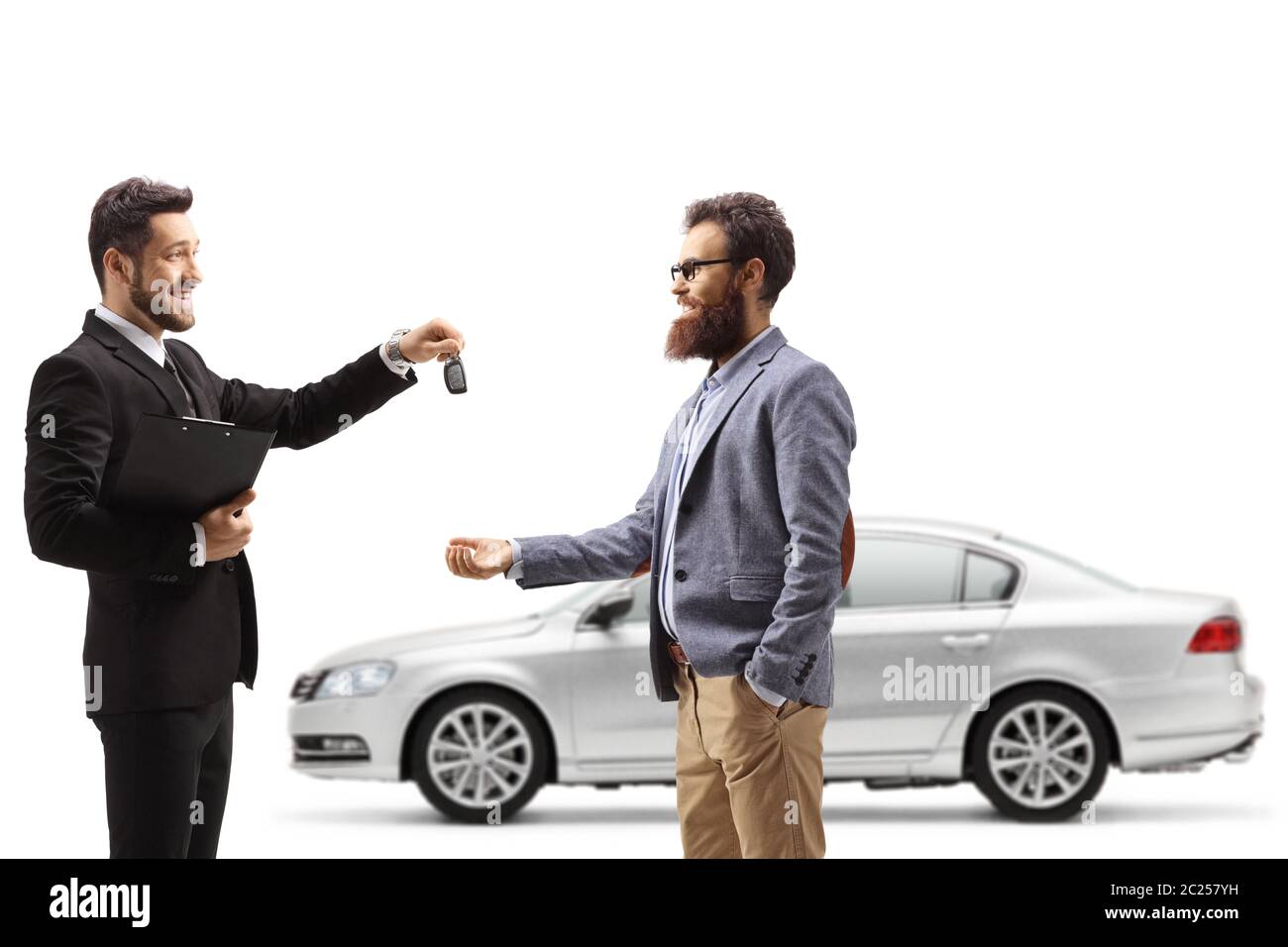 Salesman handing car keys to a male customer isolated on white ...