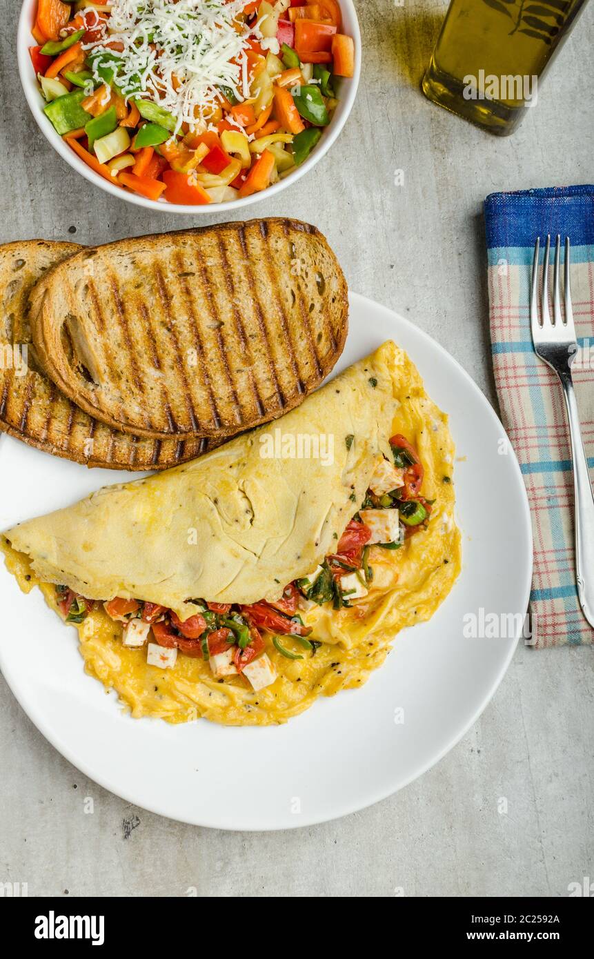 Mediterranean-Style Omlette with crispy garlic bread and apple juice ...
