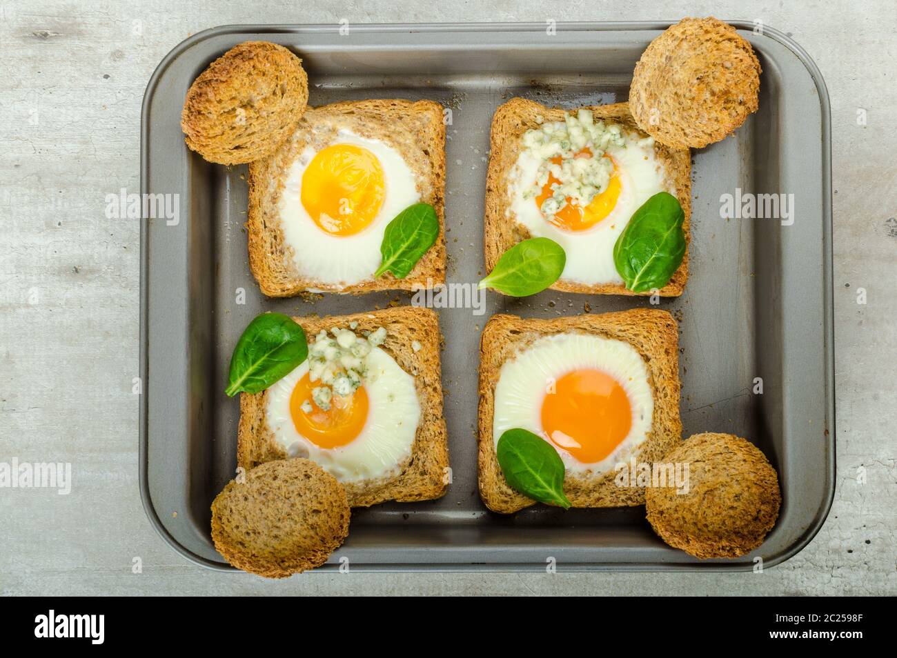 Baked Bull's-Eye Eggs on whole wheat toast with spinach and blue cheese ...
