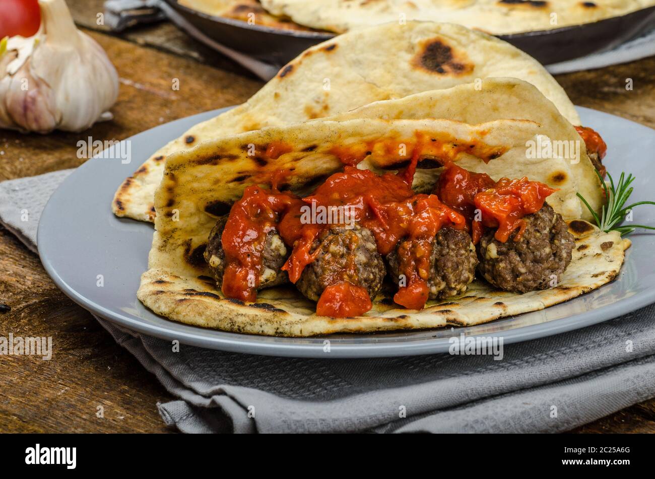 Indian naan with meatballs and tomato sauce, spicy sauce and exotic ...