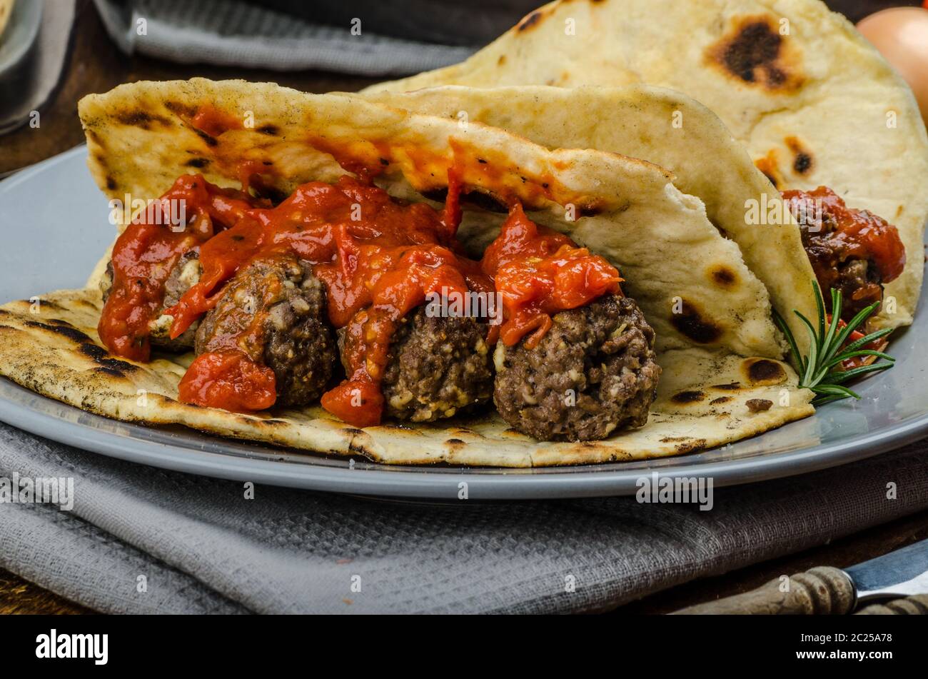 Indian naan with meatballs and tomato sauce, spicy sauce and exotic ...