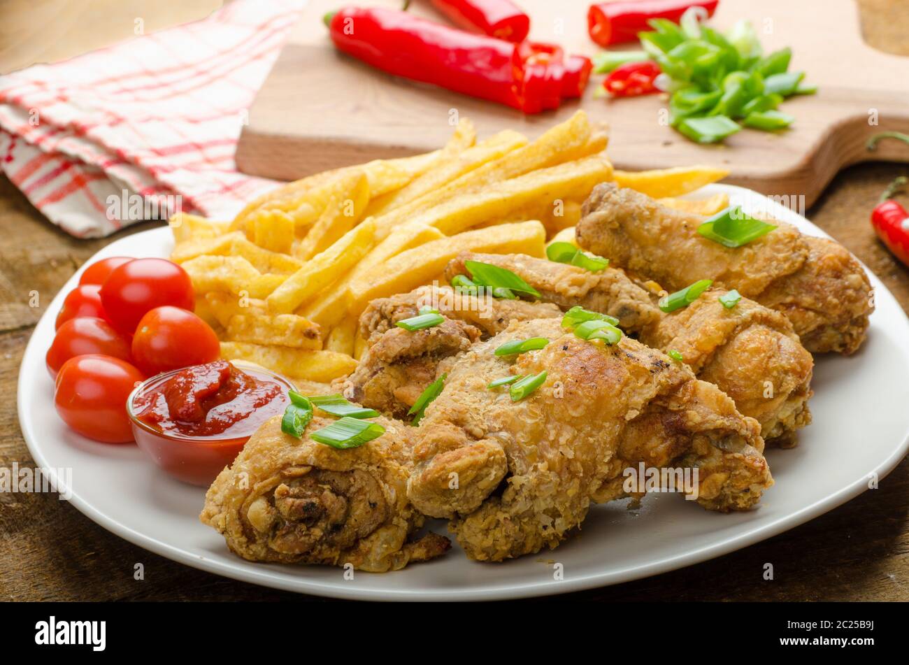 Fried chicken, chilli fries and dip and spring onions on top of meal ...