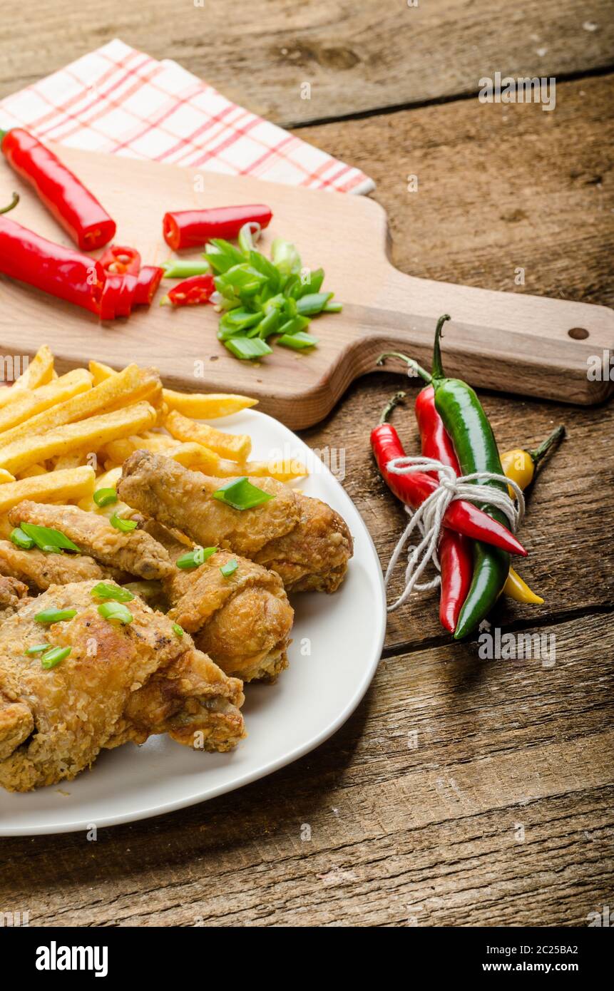 Fried chicken, chilli fries and dip and spring onions on top of meal ...