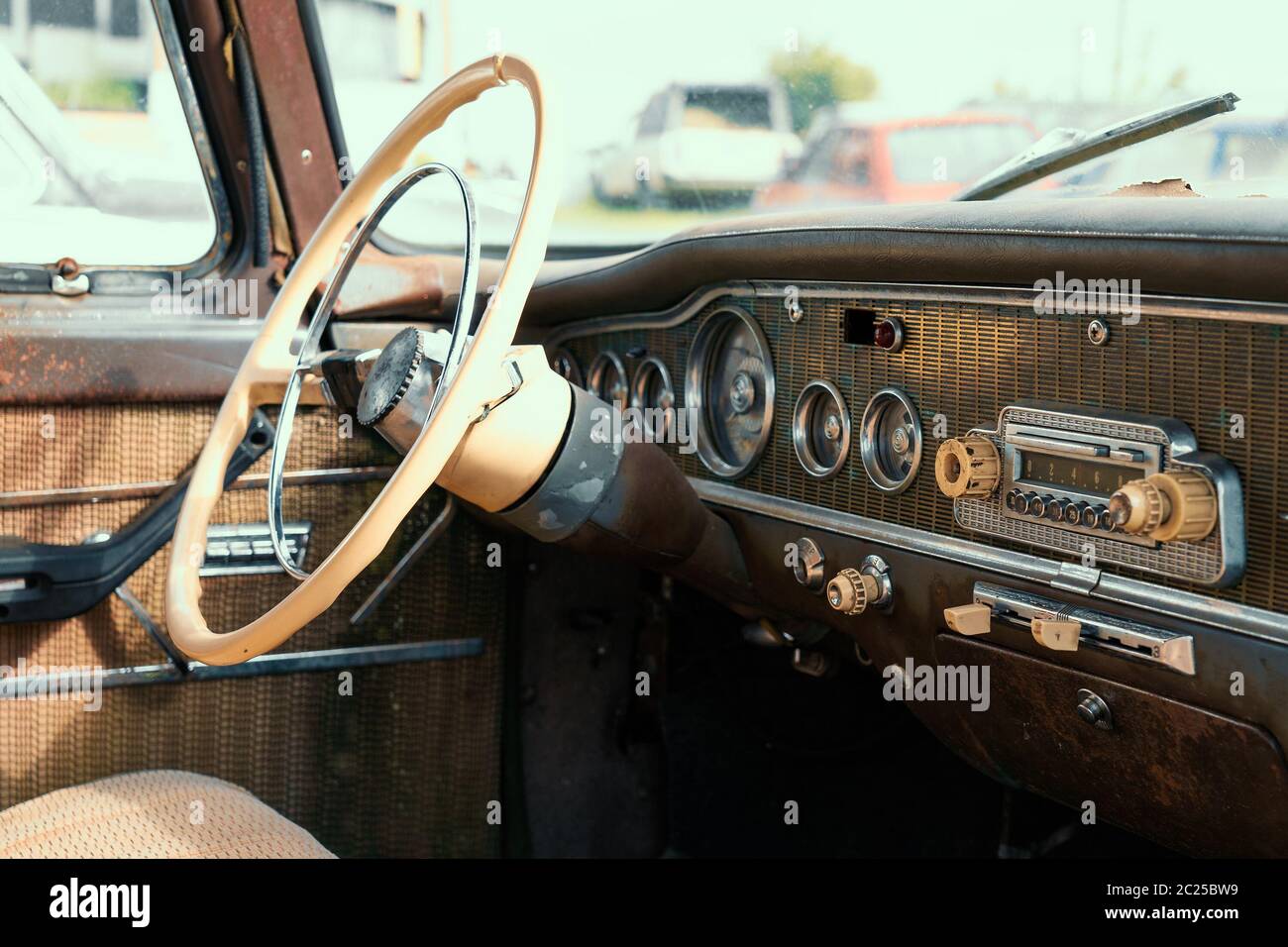 Close-up wheel and panel of old vintage rusty abandoned car, toned ...