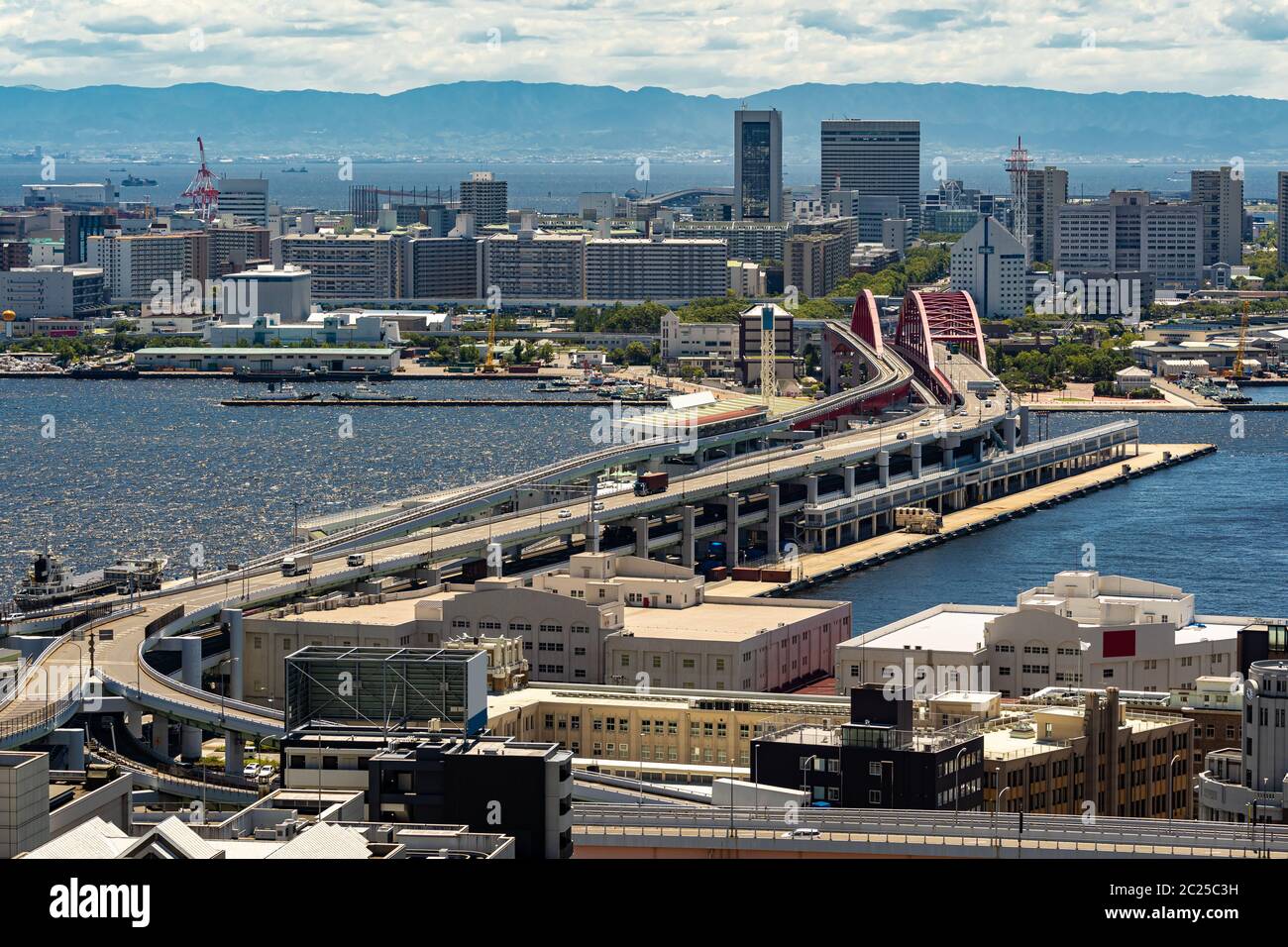 Aerial view of Kobe cityscape and red bridge at port area in Kobe ...