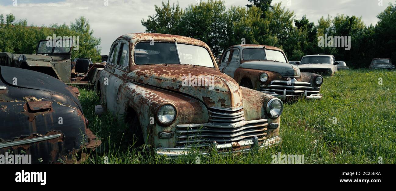 Dump of rusty old vintage cars, retro autos collection Stock Photo - Alamy
