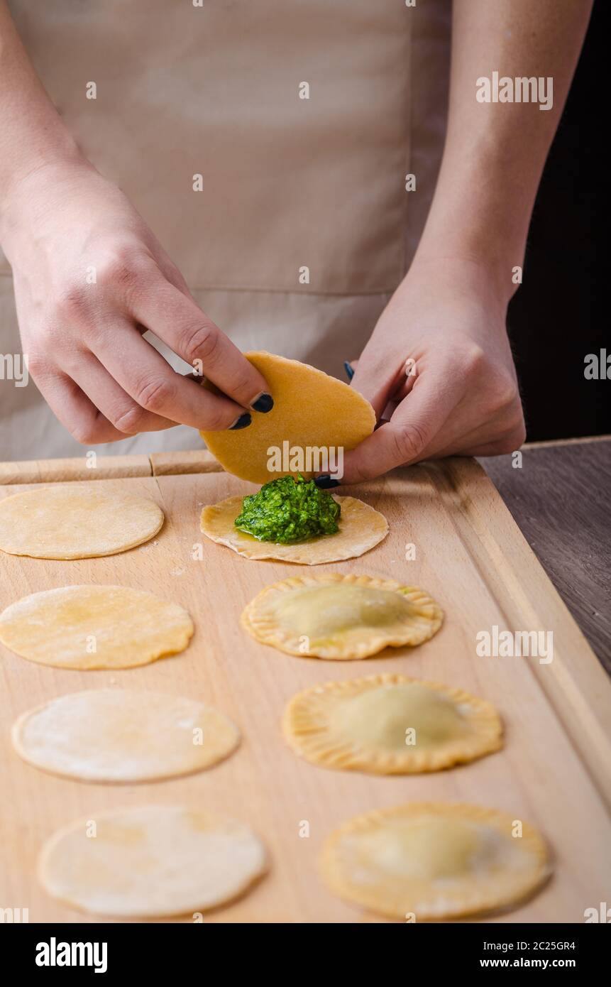 Chef prepares ravioli stuffed with spinach pesto Stock Photo - Alamy