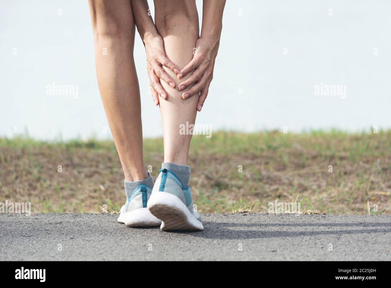 The female clings to a bad leg. The pain in her leg. Health and painful ...