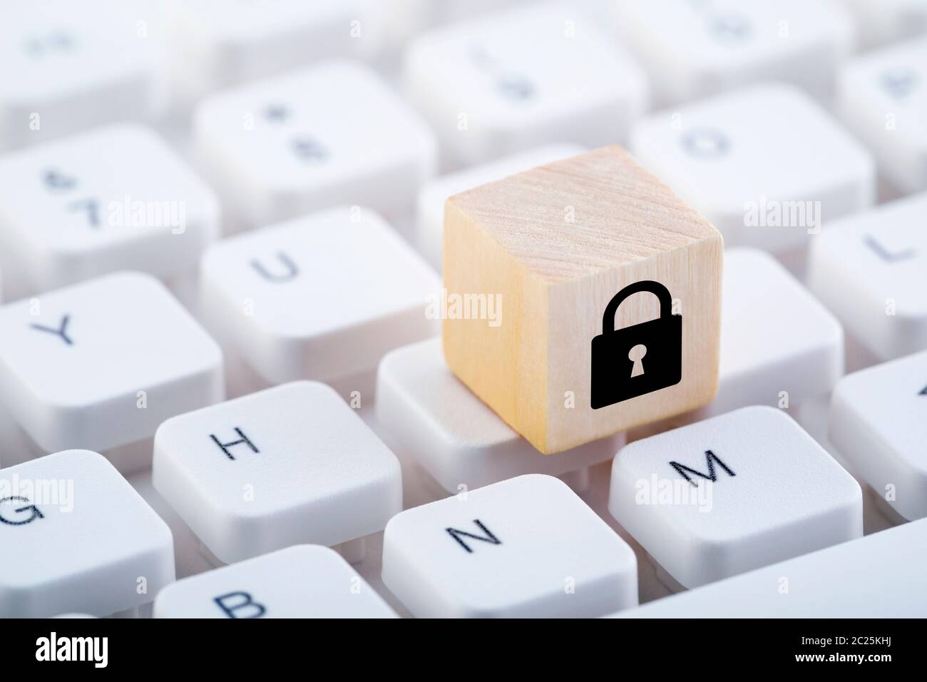 Wooden block with lock graphic on computer keyboard. Computer security ...