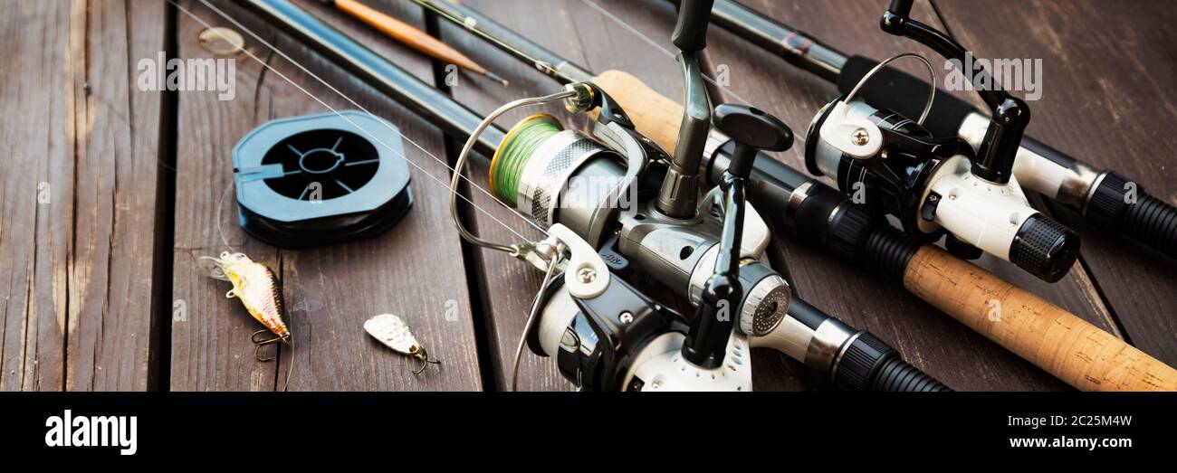 Fishing rods and accessories on wooden background with text space Stock ...
