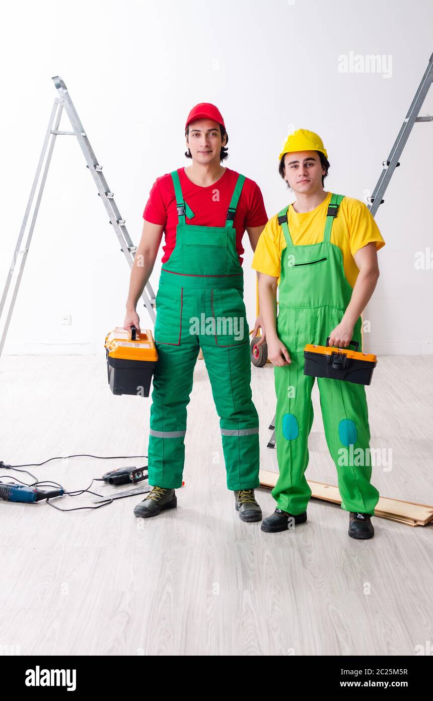 Two workers contractors working indoors Stock Photo - Alamy
