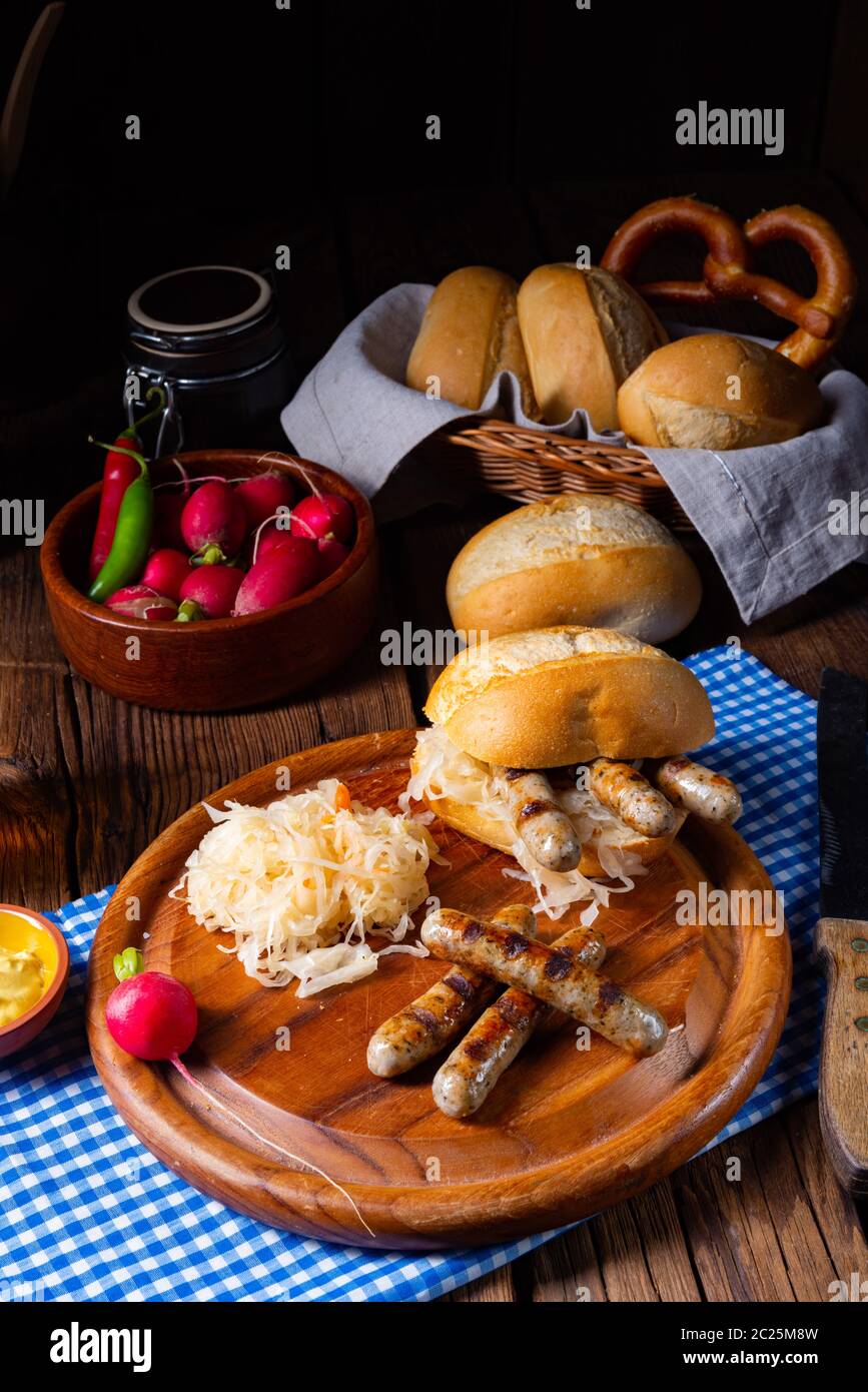 rustic Thuringian bratwurst with sauerkraut and roll Stock Photo - Alamy