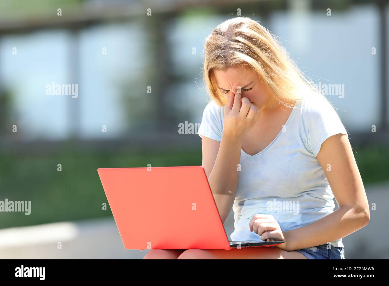 Student with eyesight problems suffering eyestrain outdoors in an ...