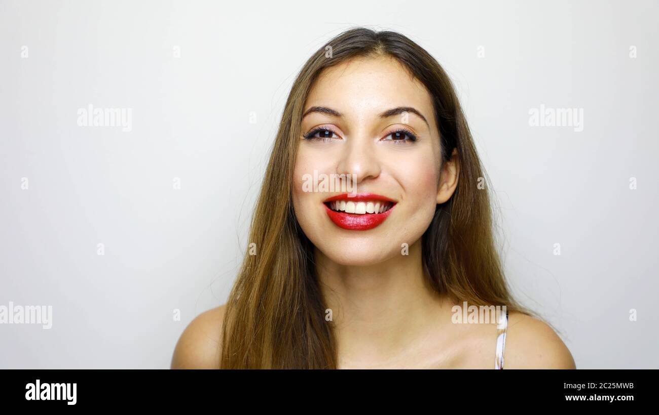 Portrait of young beautiful shy girl smiling looking at camera over ...
